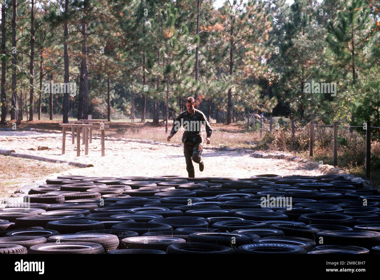 A participant runs through an obstacle course, one of several ...