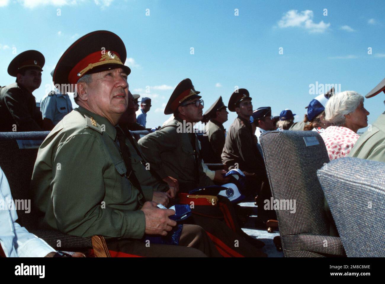 Soviet and American officers and their guests watch an air show ...