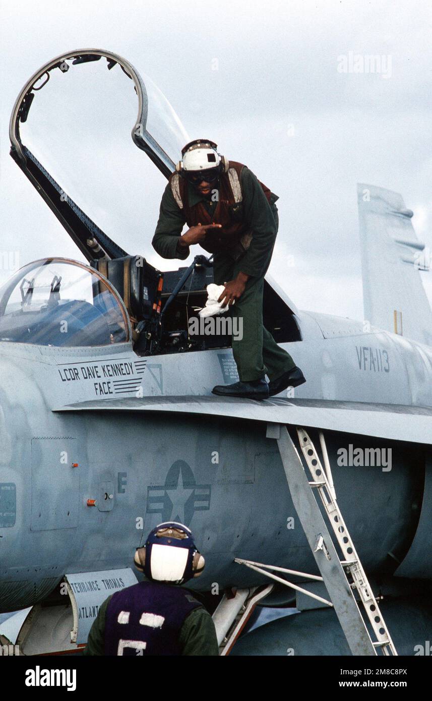 An air crew member prepares to wipe the windows of a Strike Fighter ...