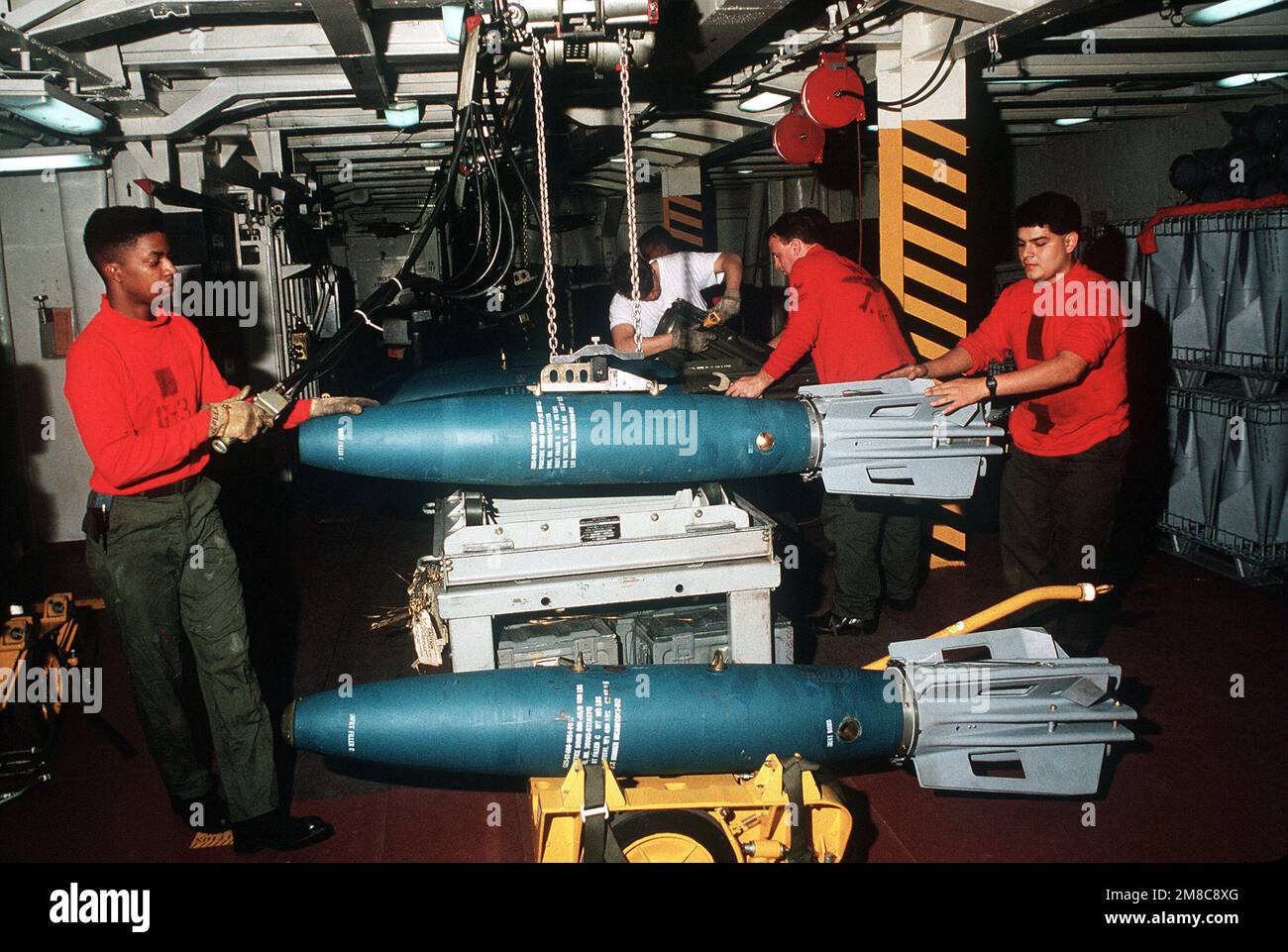 Aviation ordnancemen assemble BDU-45/B 500-pound practice bombs in a ...