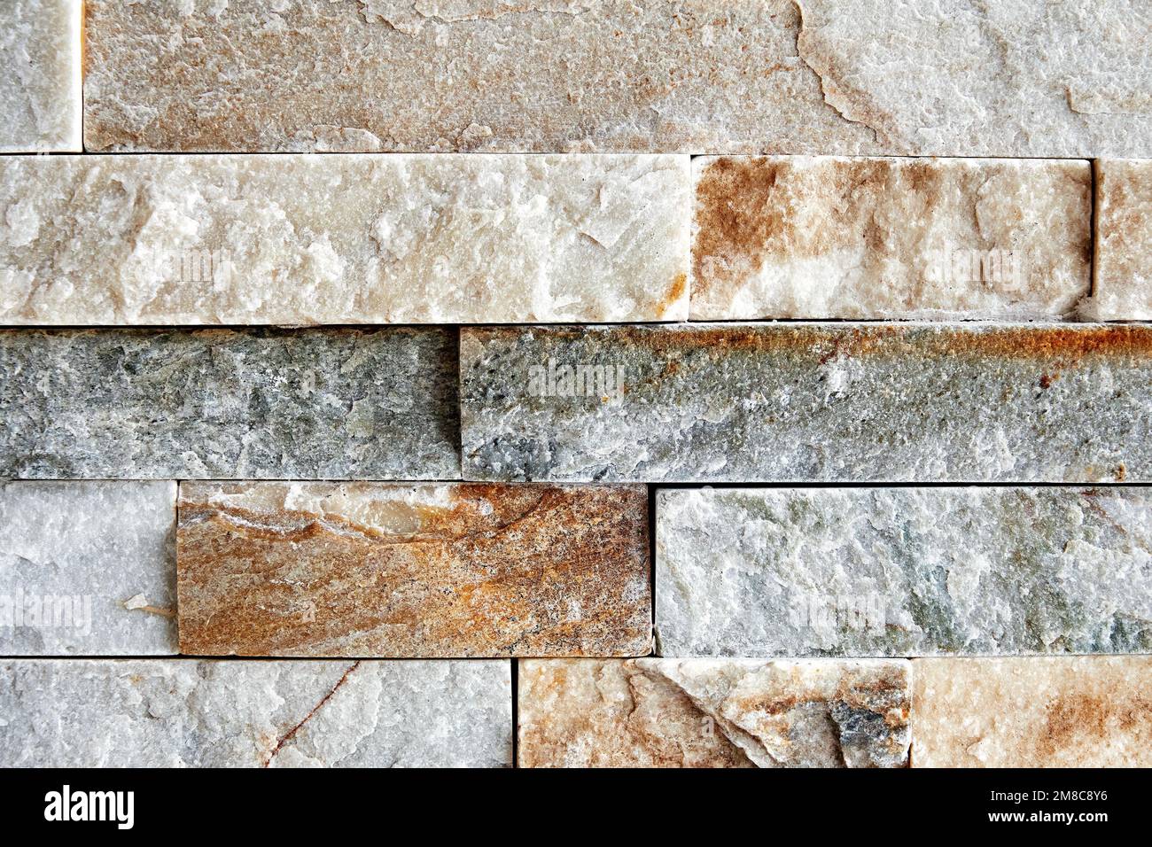 Solid brick wall from the multicolored stone bricks. Natural ...