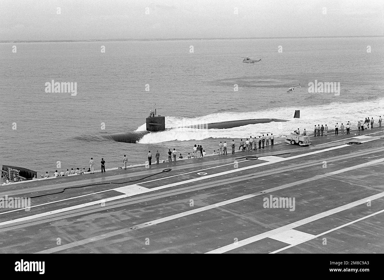 The nuclear-powered attack submarine USS HELENA (SSN-725) passes the ...