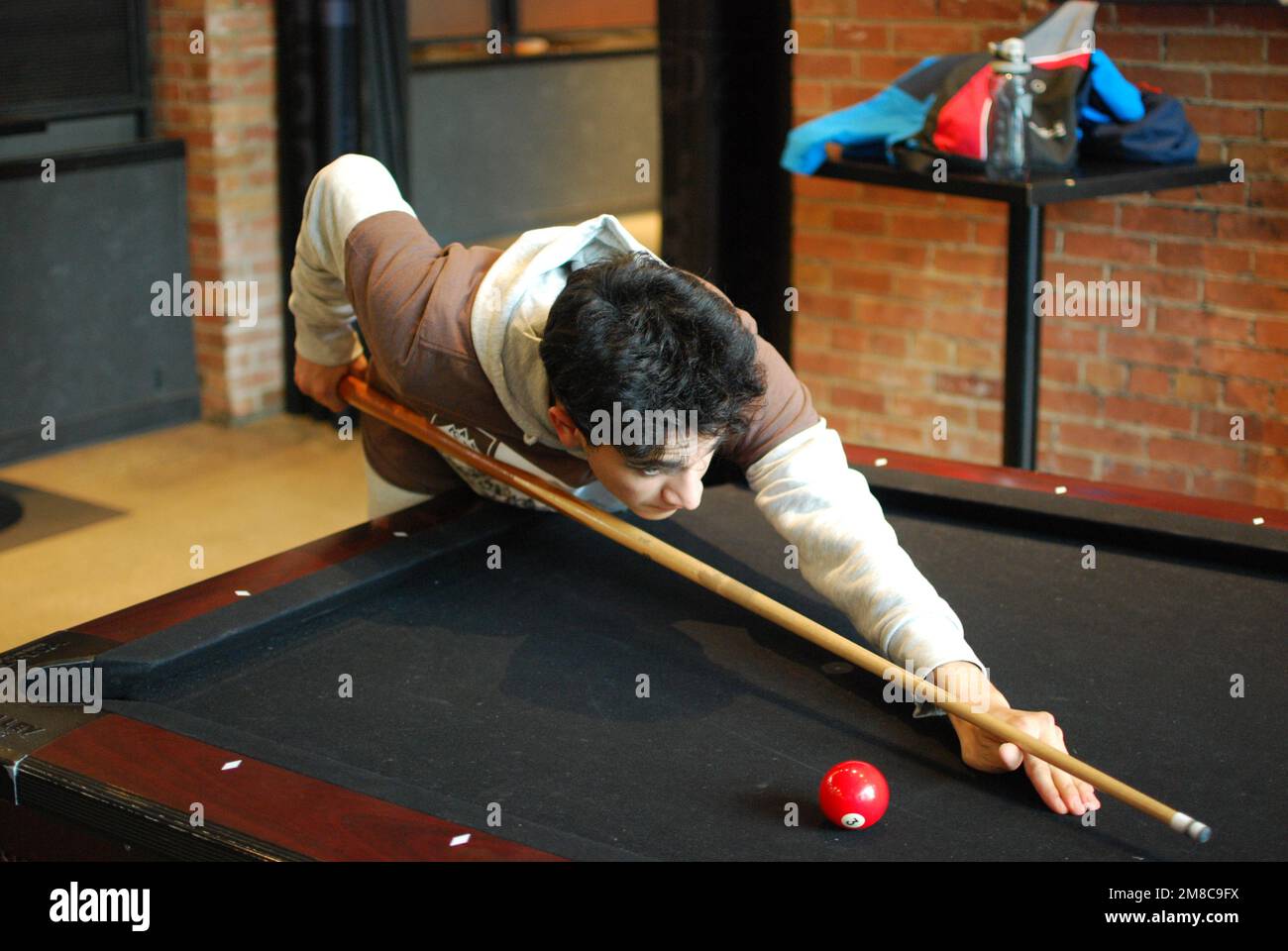 Teenager playing pool Stock Photo - Alamy
