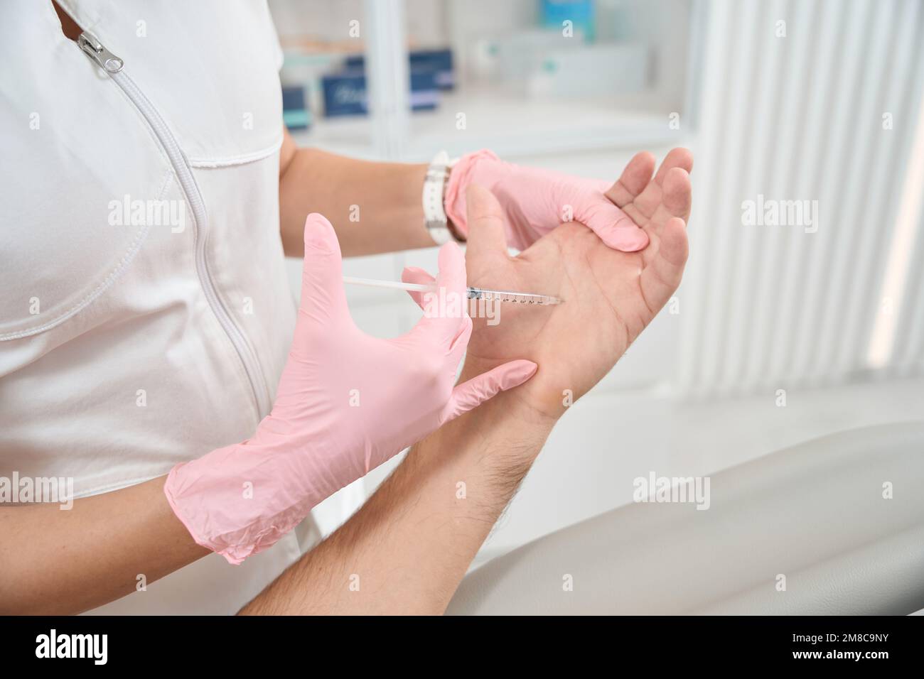 Doctor makes an injection to the patient in the palm Stock Photo - Alamy