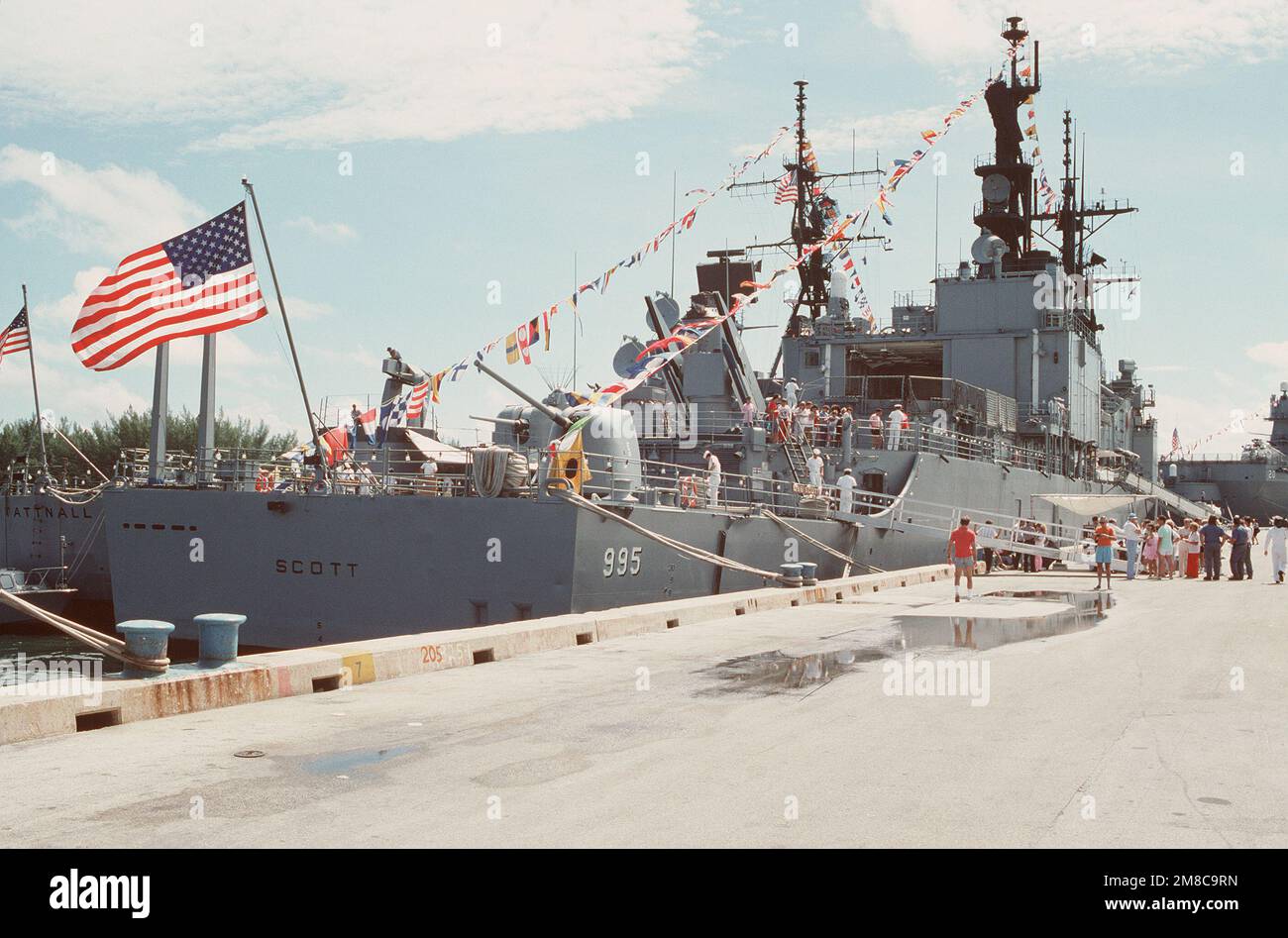 Guests wait on the pier for a tour of the guided missile destroyer USS ...