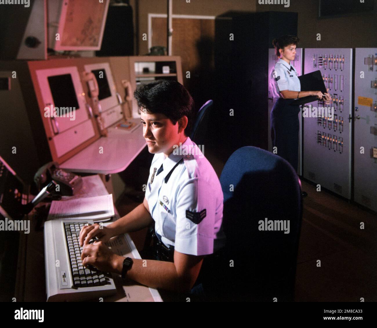 AIRMAN 1ST Class Lisa Stout dispatches security police, while SENIOR ...