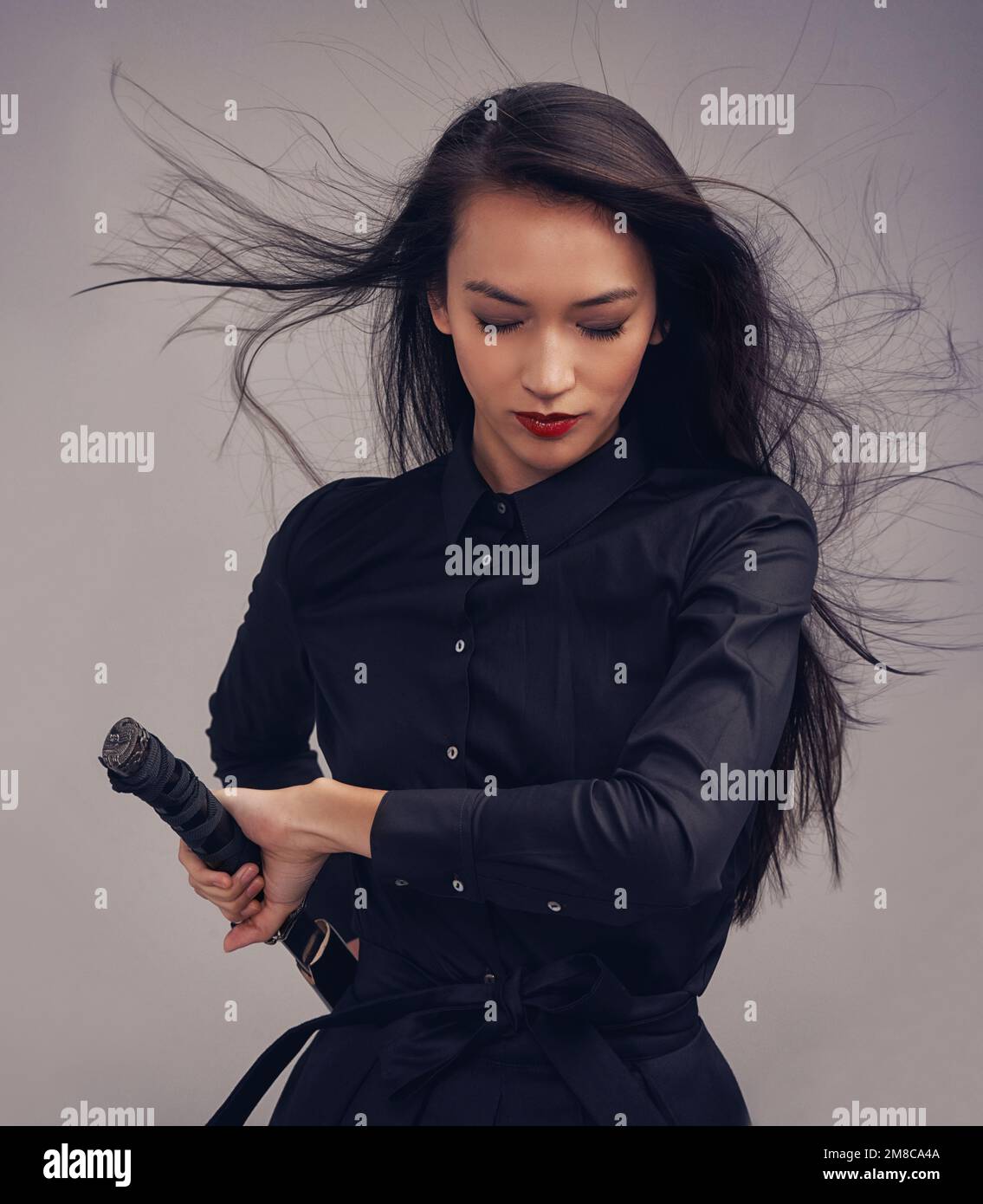 Samurai, ninja and woman with sword in studio isolated on a gray background. Face, sports and ...