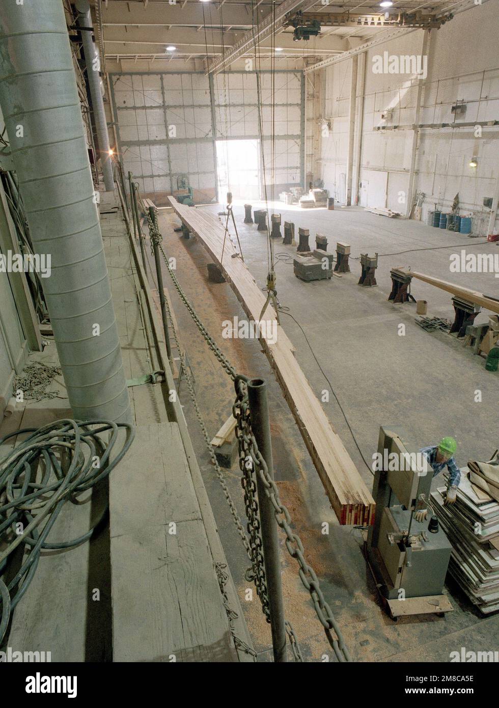 A worker shapes sections of the skeg (rear extension of the keel) of ...