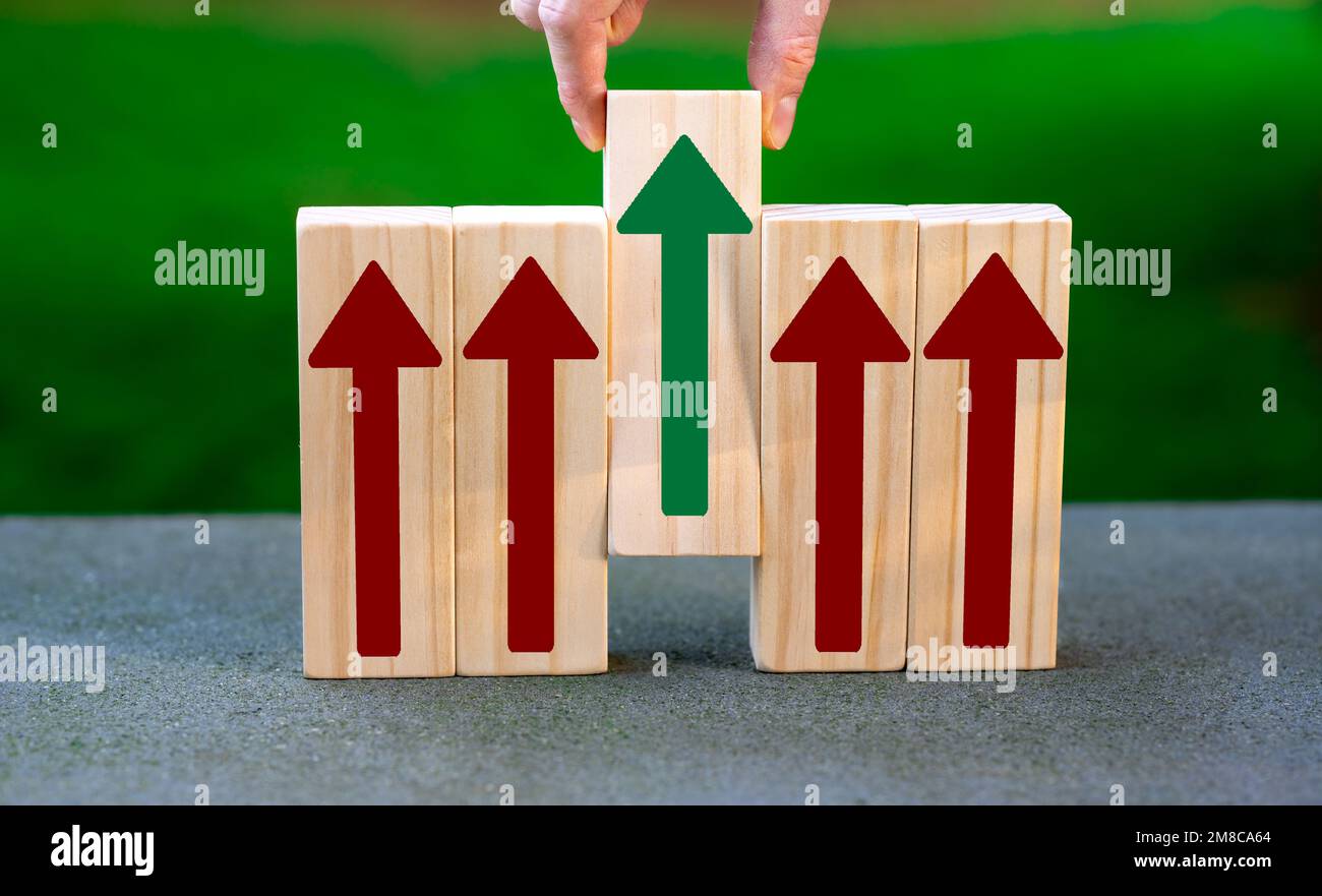 Wooden blocks with arrows pointing upwards. Hand selecting one block ...