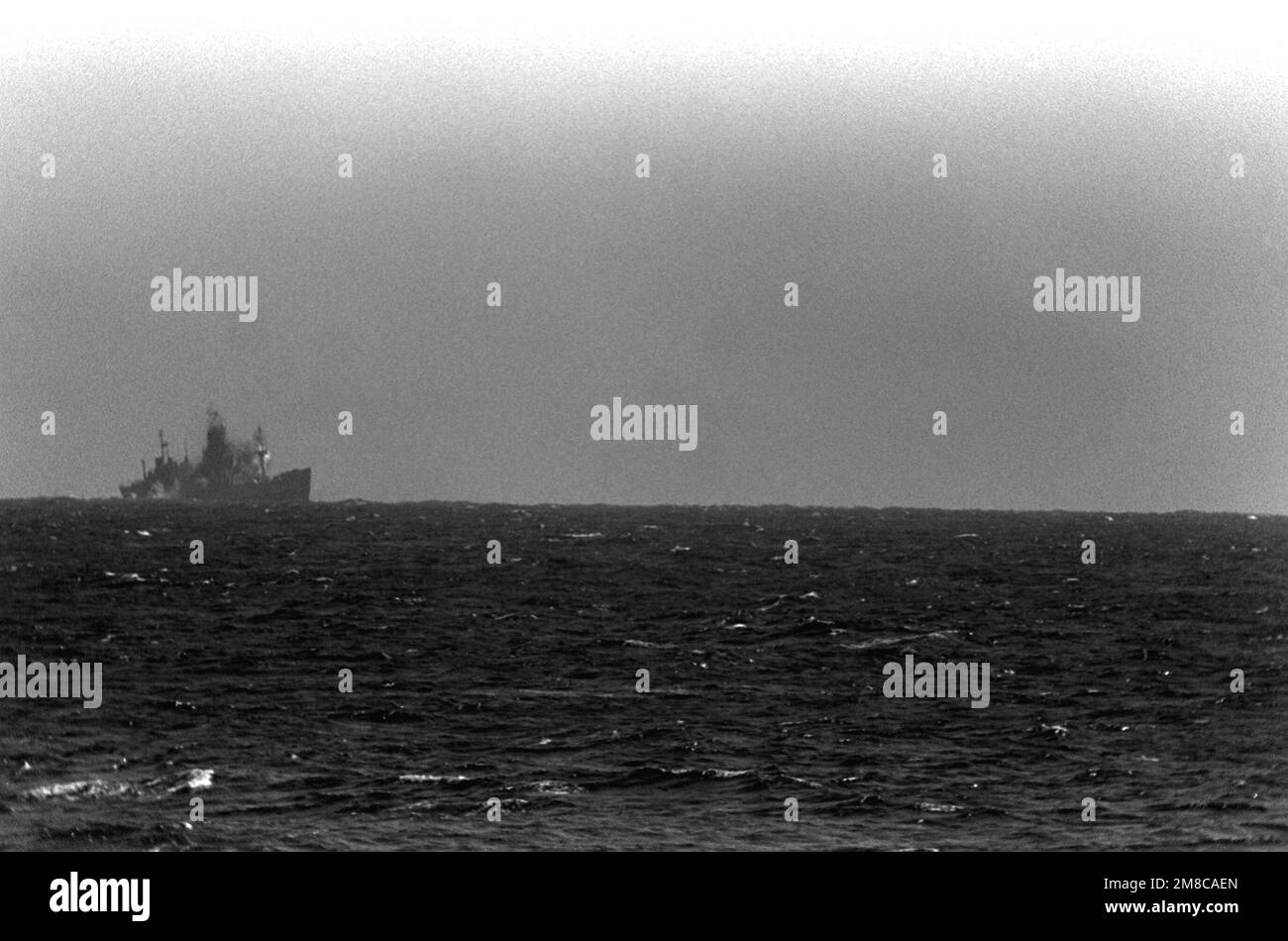 A 16-inch projectile lands just short of the target ship being fired at ...