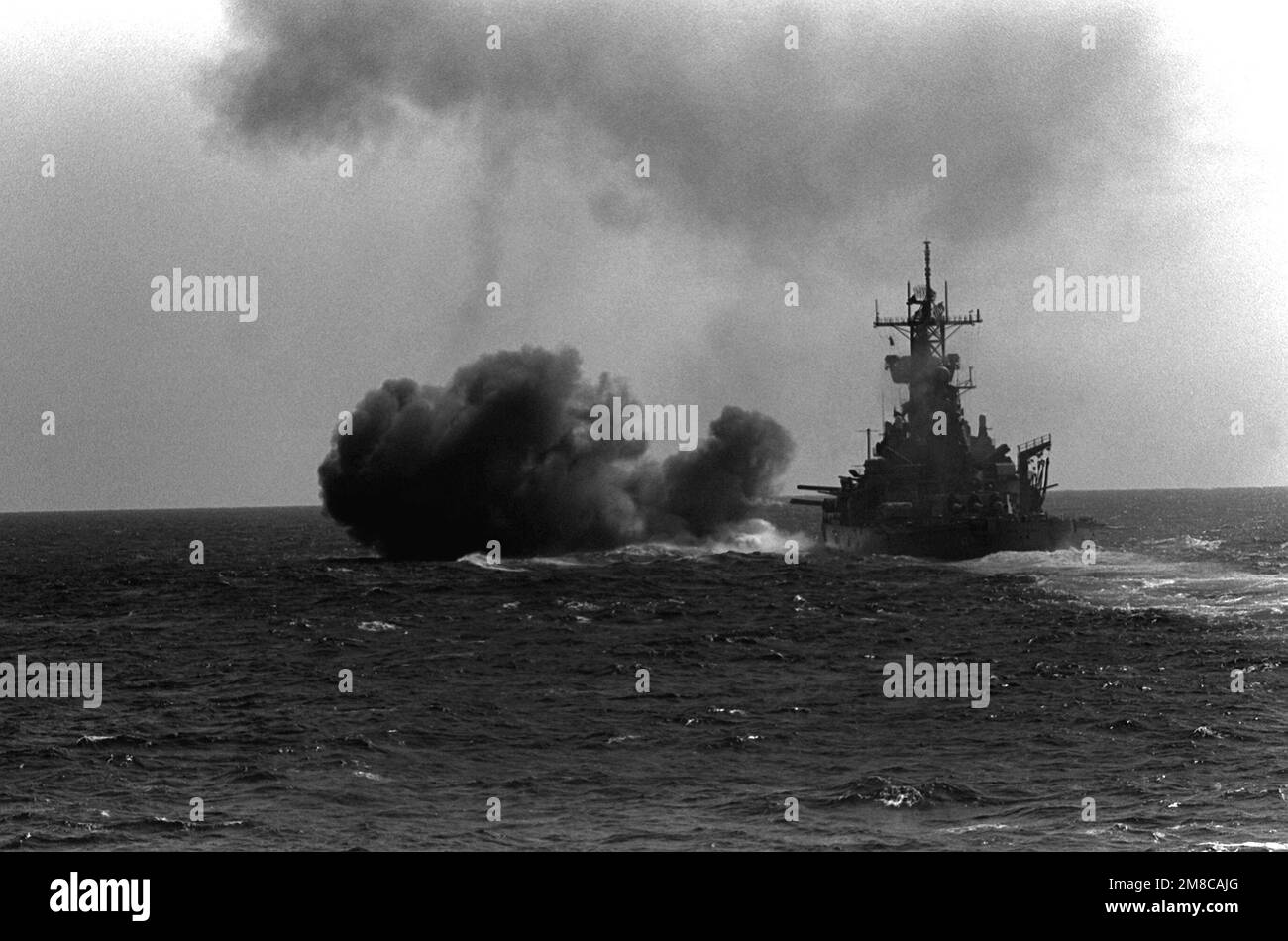 Smoke billows from the muzzle of one of the turret No. 1 Mark 7 16-inch ...