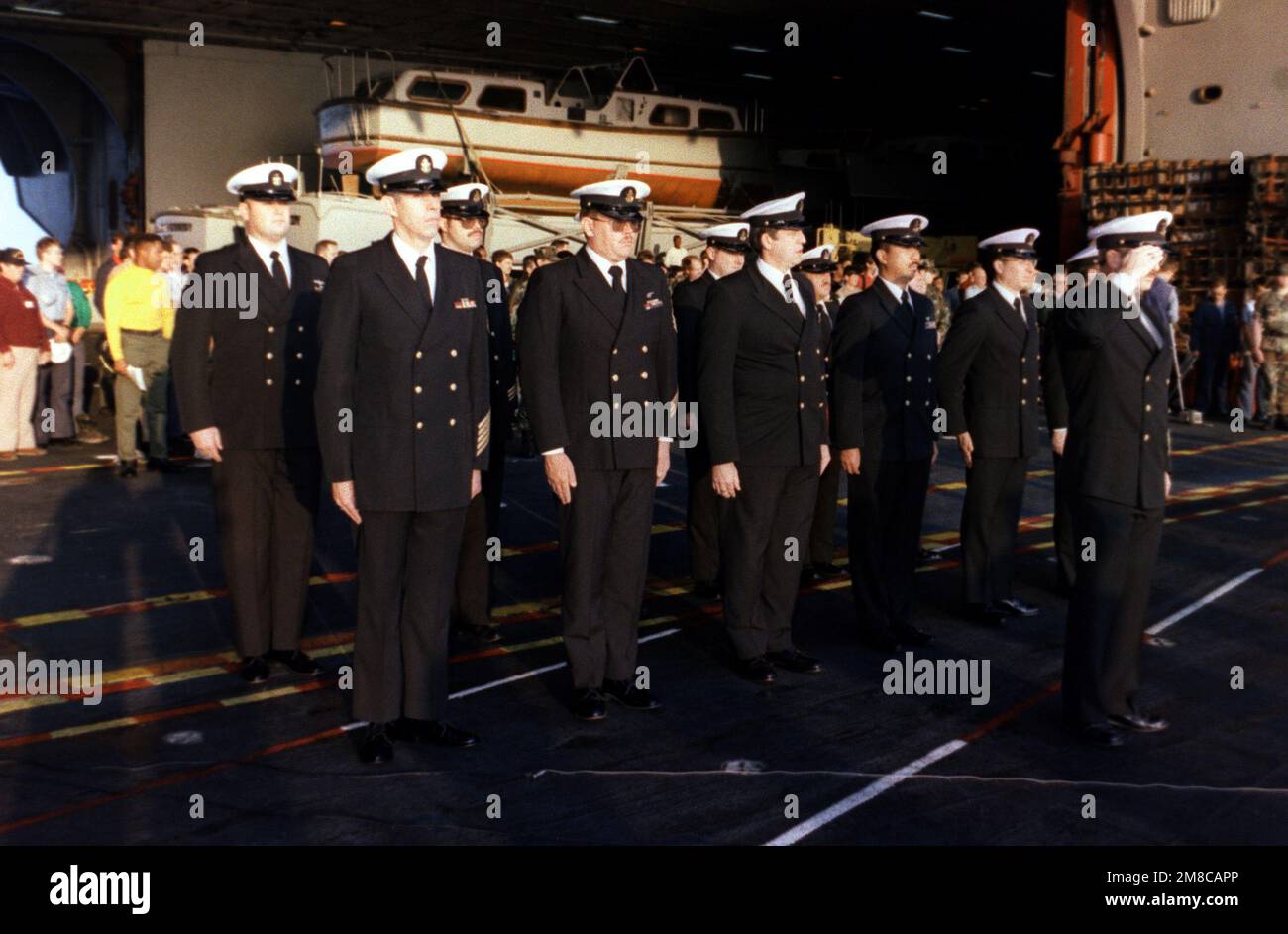 CHIEF petty officers stand in formation during a burial at sea service ...