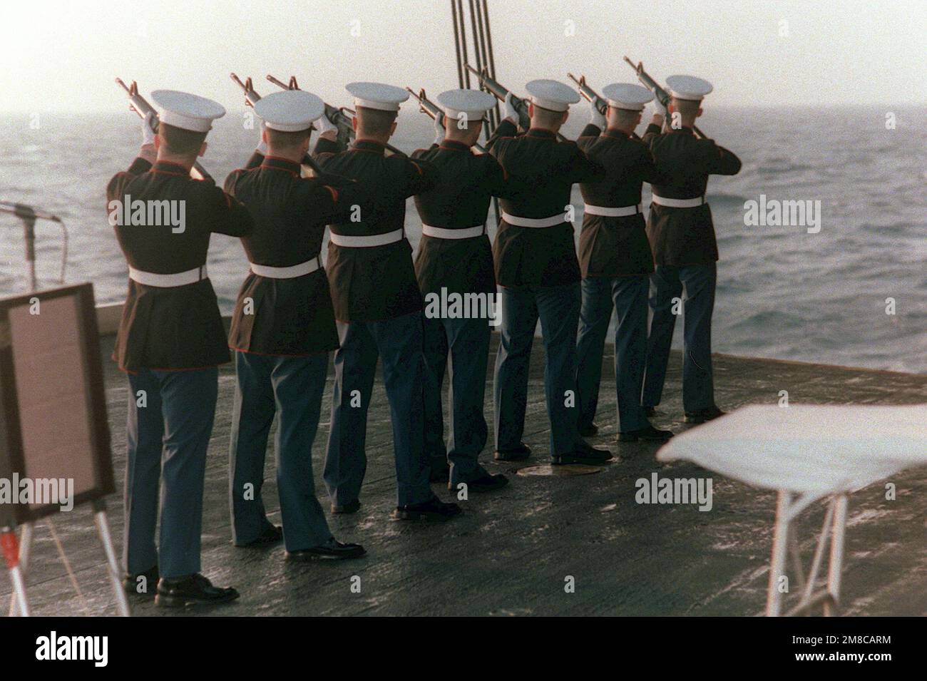 US Marines fire a volley during a burial at sea service aboard the ...
