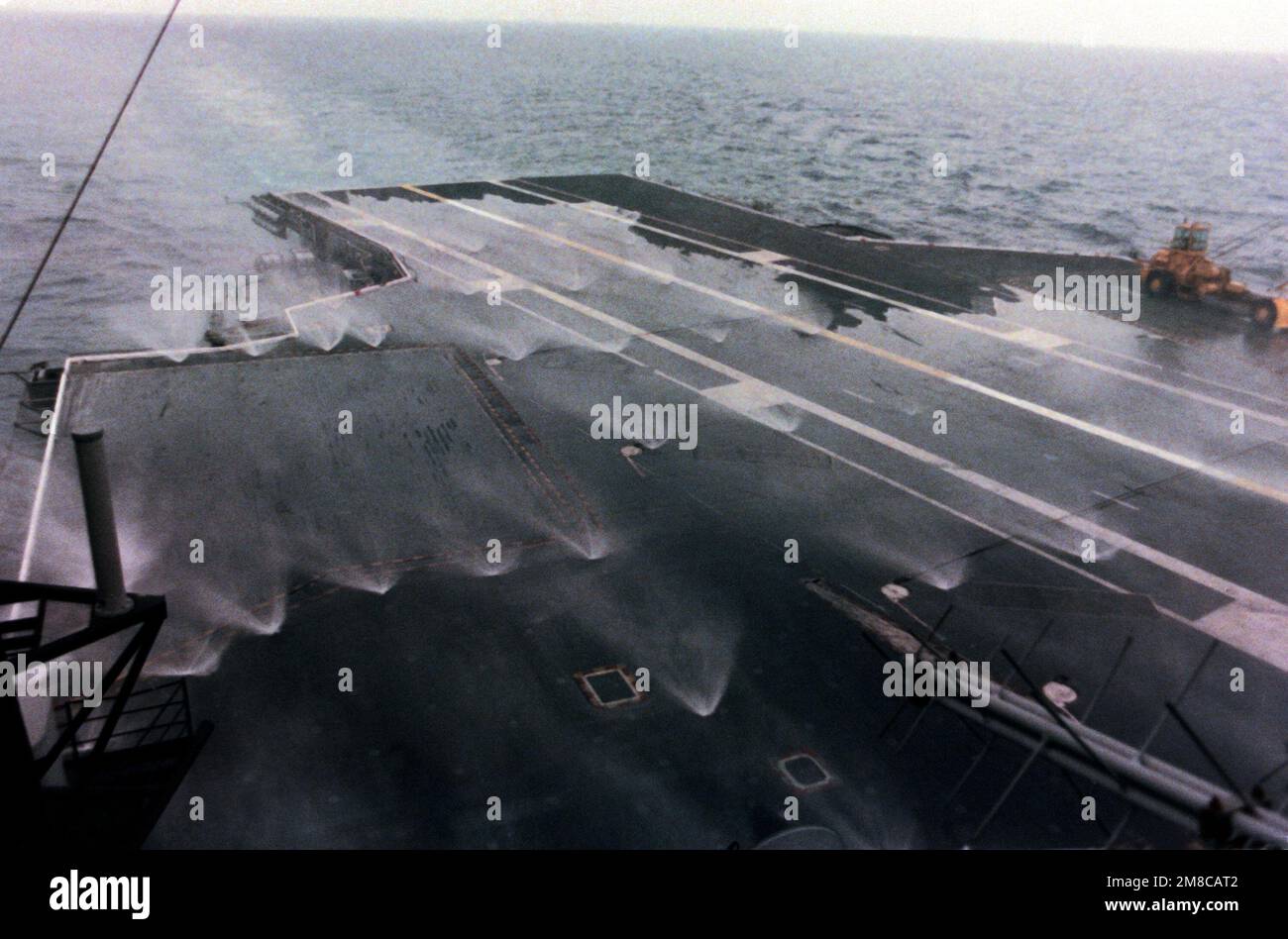 The flight deck water washdown system is tested aboard the aircraft ...