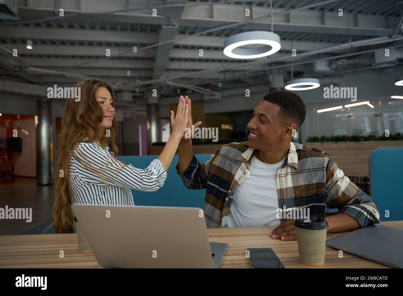 Happy man and woman rejoicing together in the lobby office Stock Photo ...