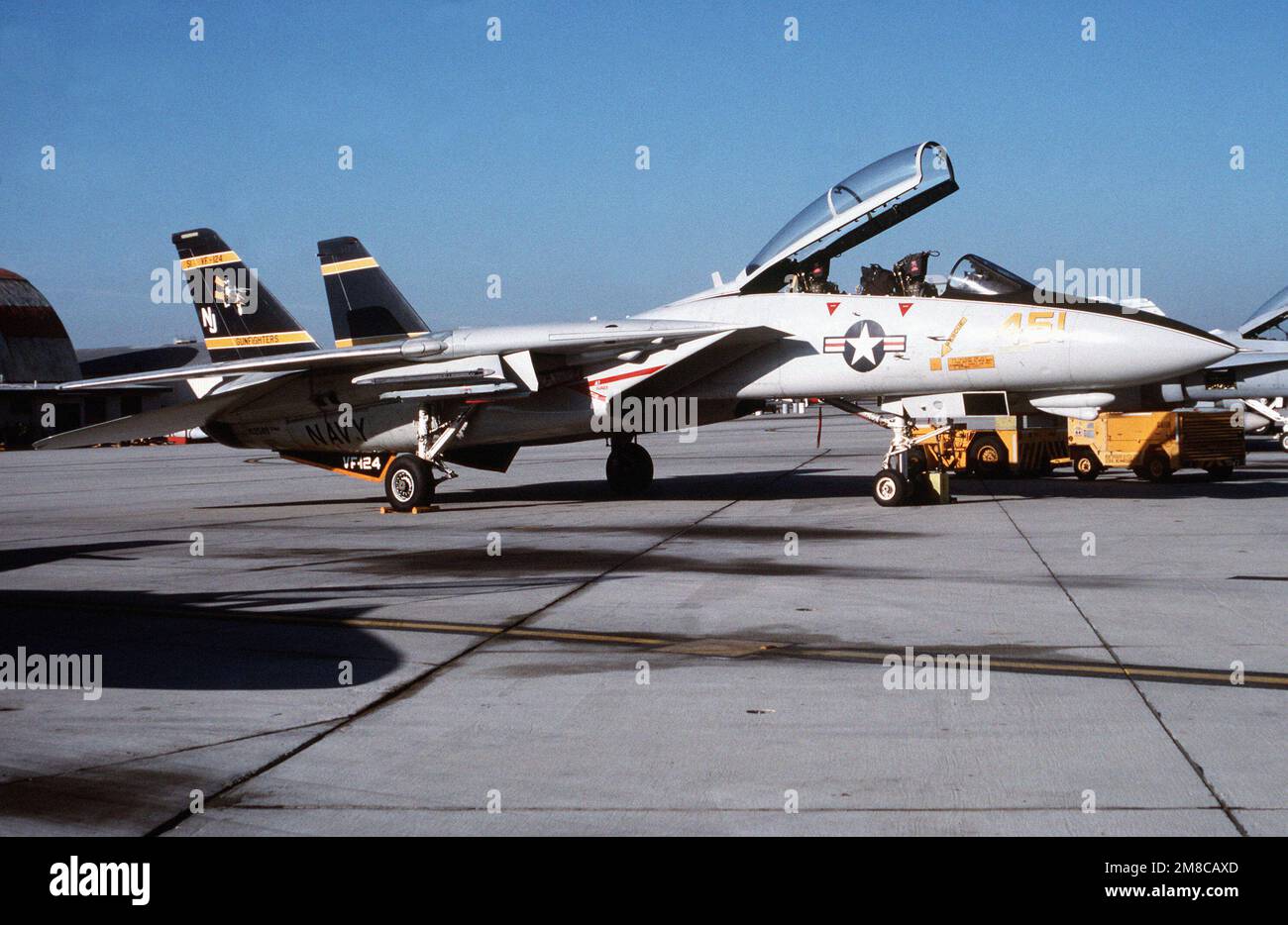 An F-14A Tomcat aircraft of Fighter Squadron 124 (VF-124) is serviced ...
