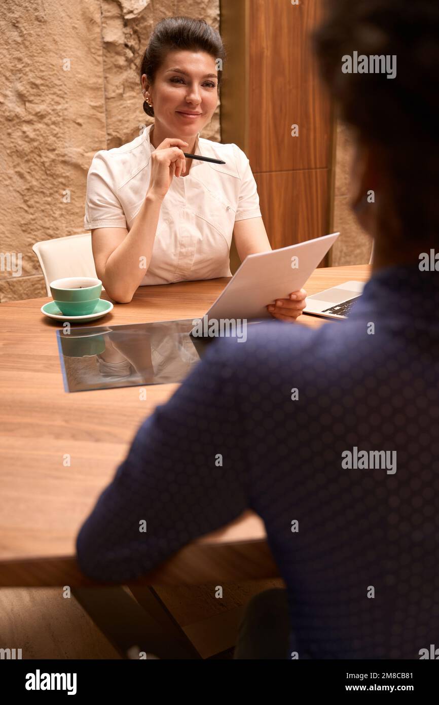 Physician working in the private clinic, talking with lady Stock Photo ...