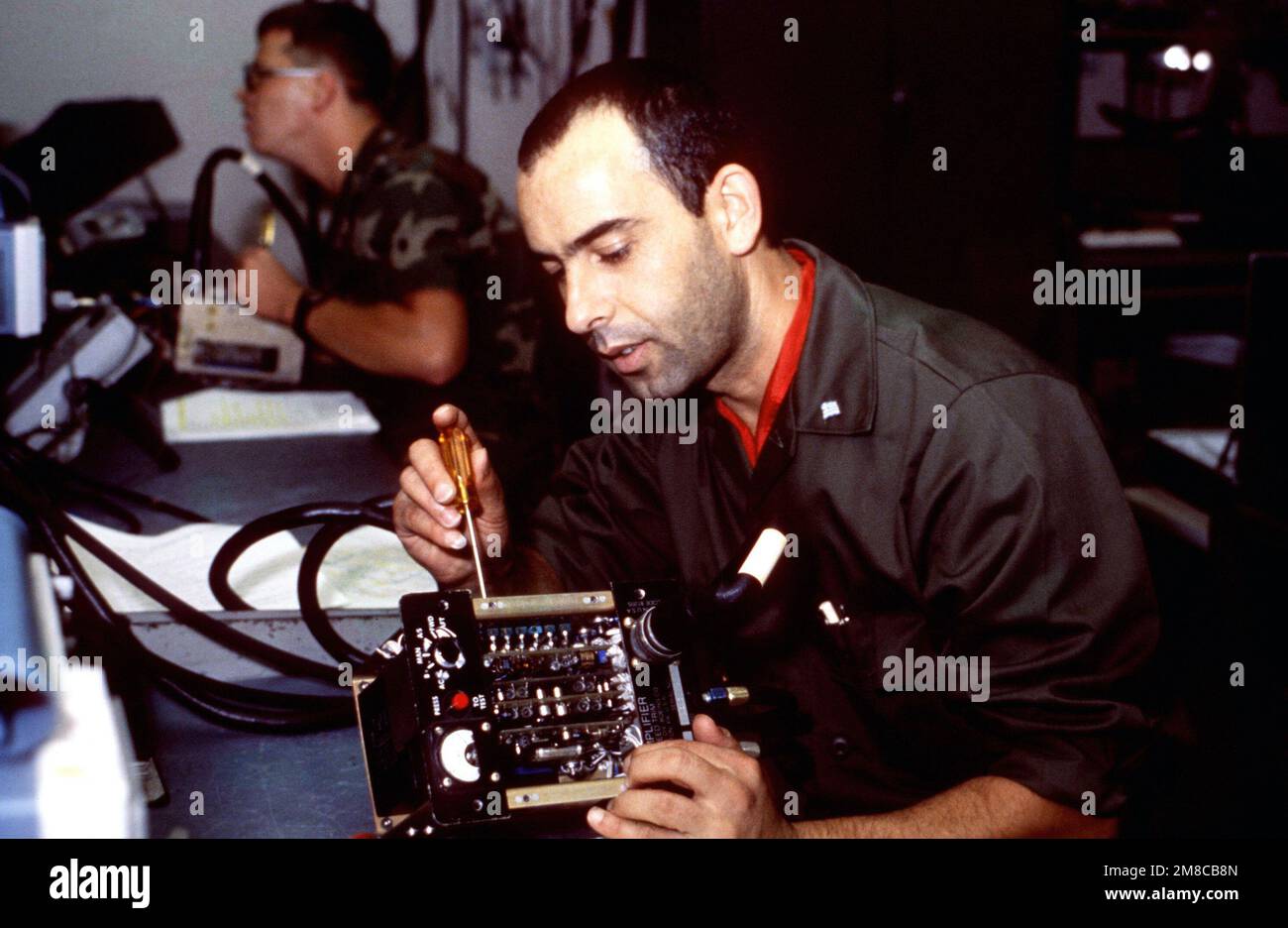 A student from the Greek armed forces reparis an automatic speed trim ...