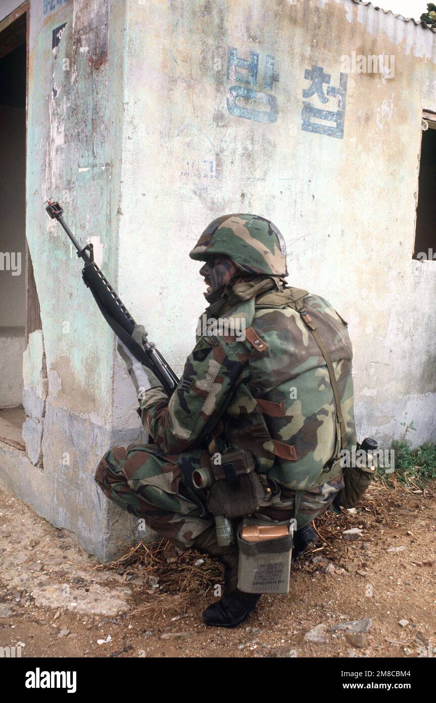An airman armed with an M-16 rifle watches for aggerssor forces during ...