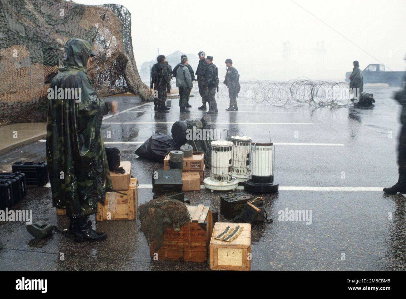 An airman stands guard over equipment to be used during the air base ...
