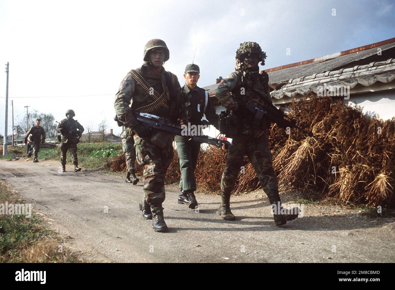 Members of the 8th Security Police Squadron patrol with a member of the ...