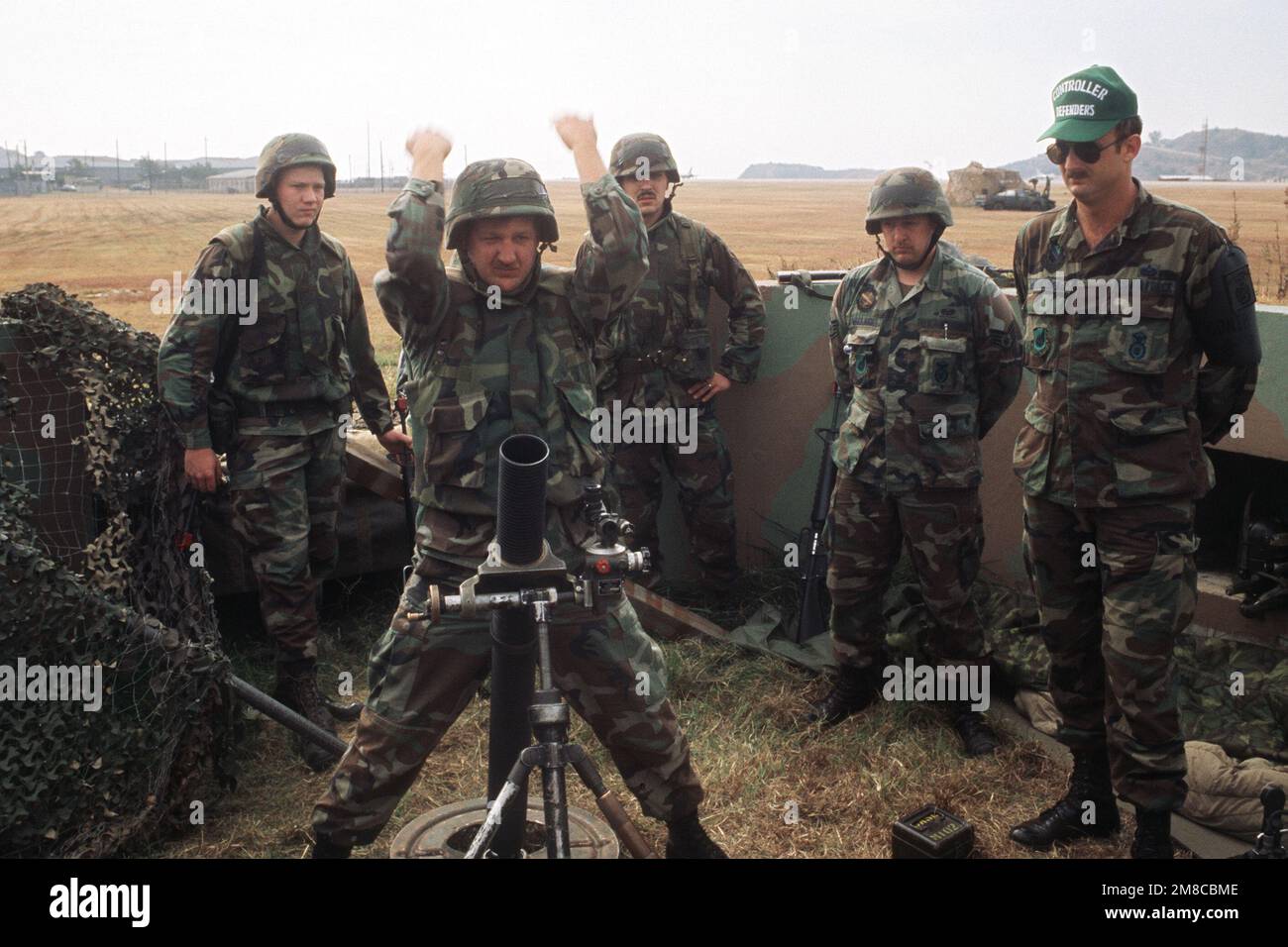 An exercise evaluator watches as members of the 8th Security Police ...