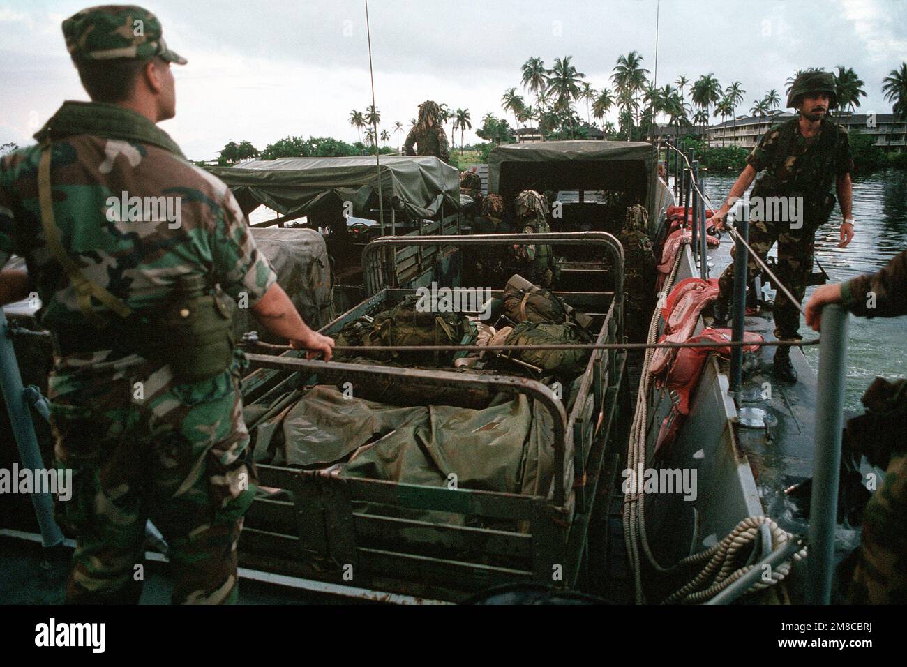 An LCM 8 mechanized landinc craft approaches shore to disembark an Army ...