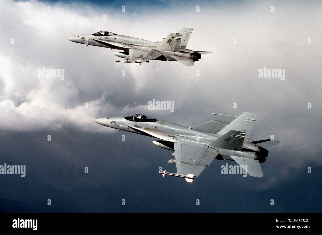 An air-to-air left side view of two F/A-18A Hornet aircraft of Strike ...