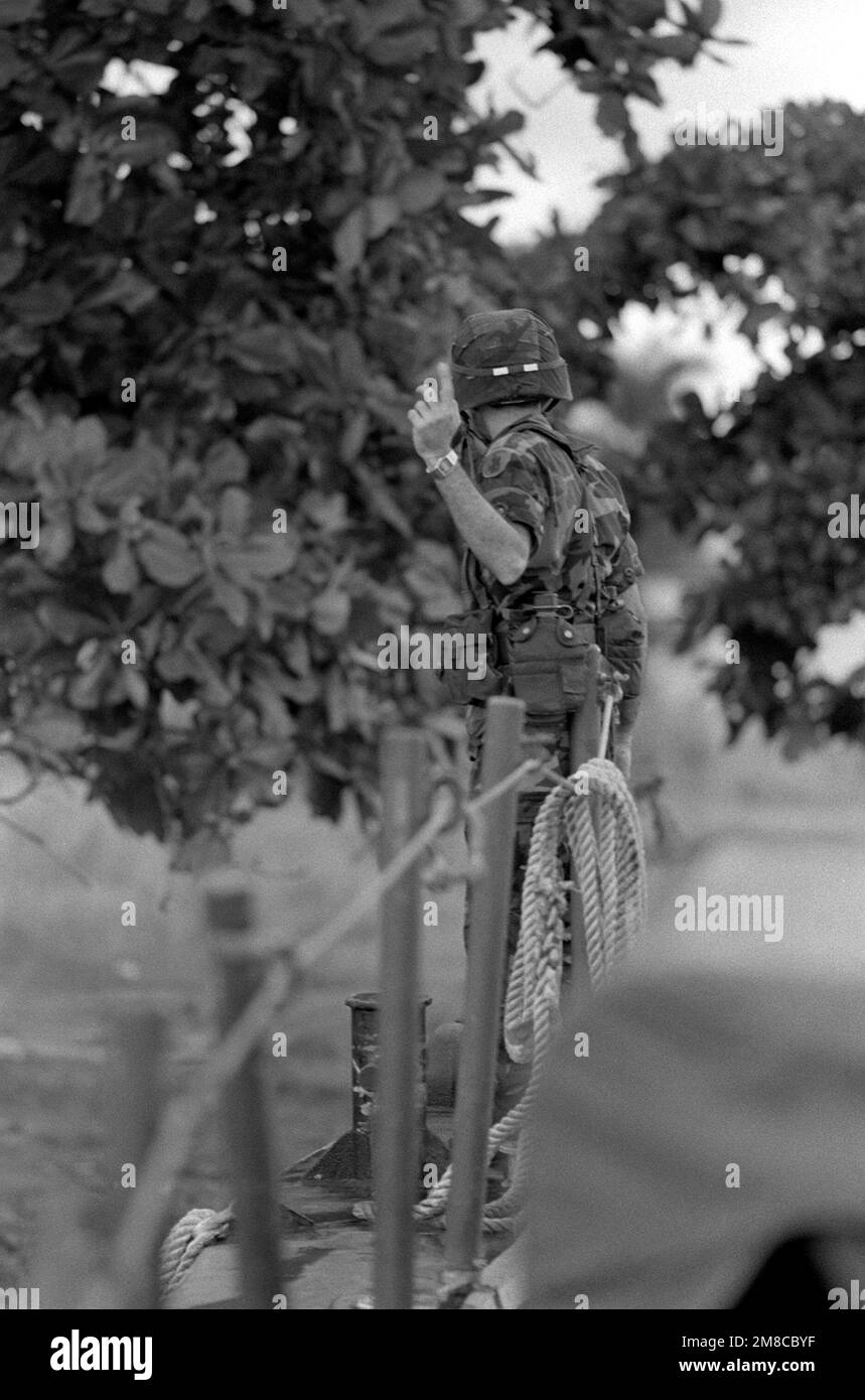 A soldier standing near the bow of an Army LCM 8 mechanized landing ...