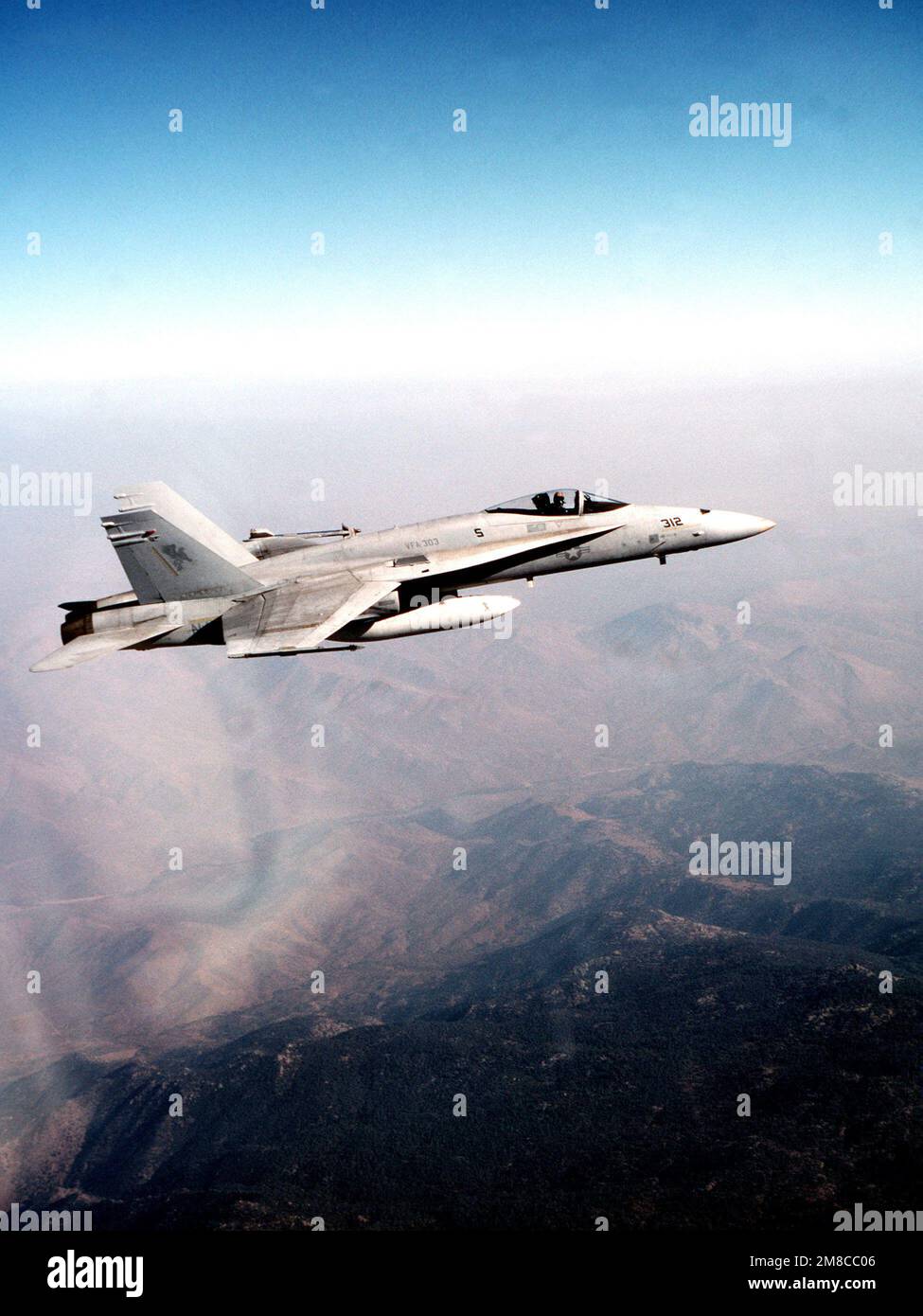 An air-to-air right side view of two F/A-18A Hornet aircraft of Strike ...