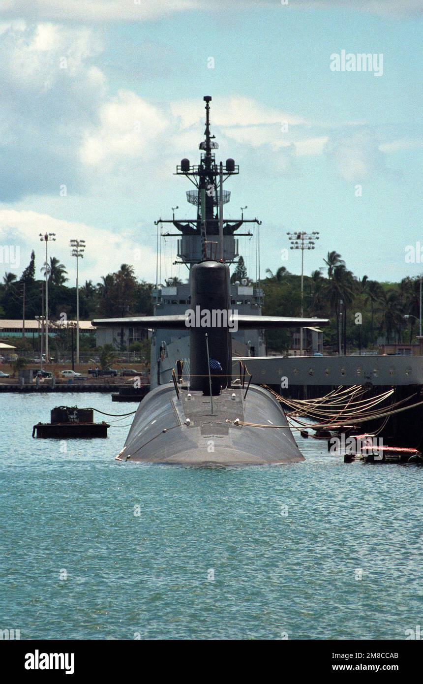 The nuclear-powered strategic missile submarine USS GEORGIA (SSBN 729) and, directly behind it ...