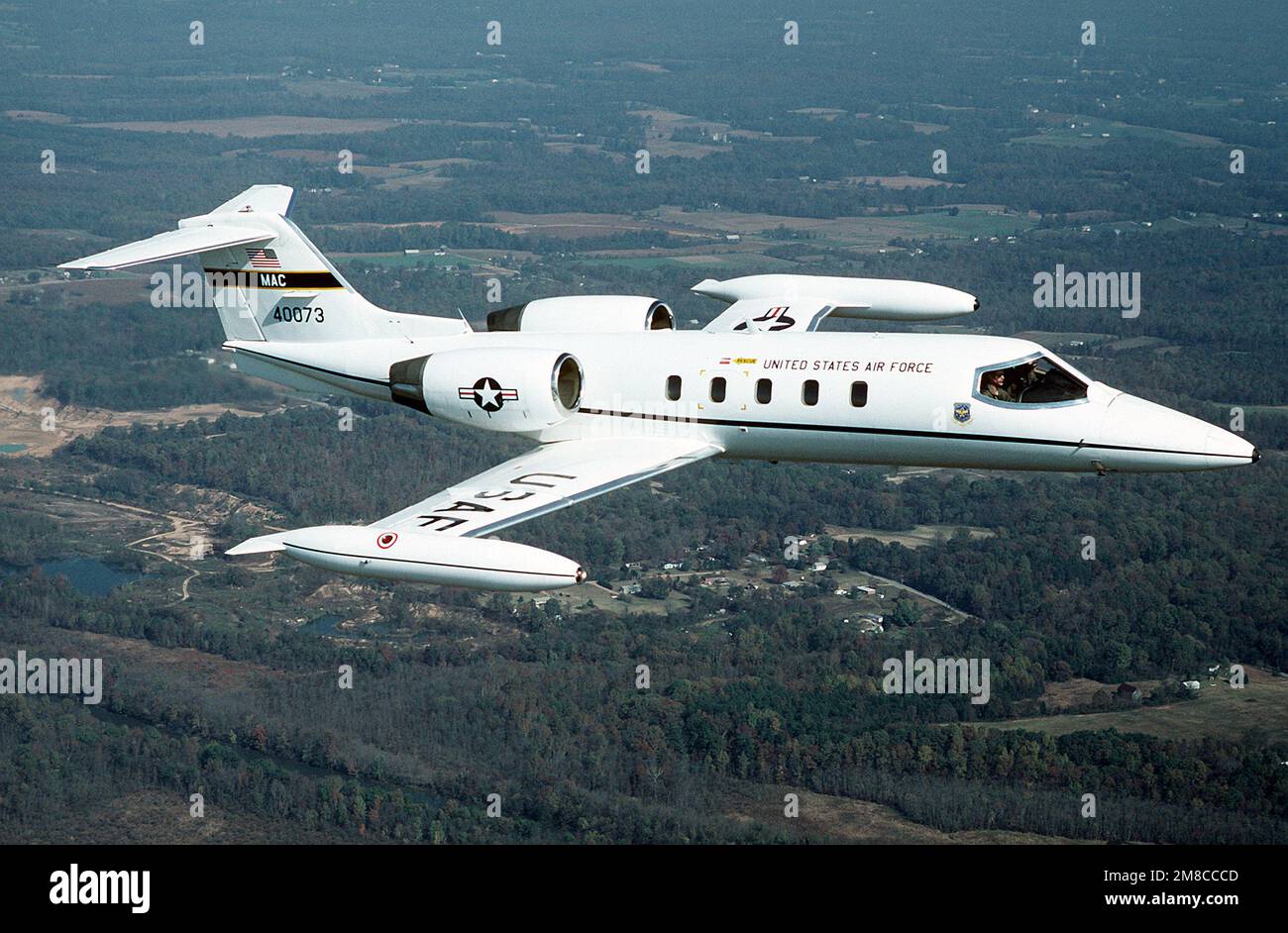 An air-to-air right side view of a C-21 aircraft of the 1402nd Military ...