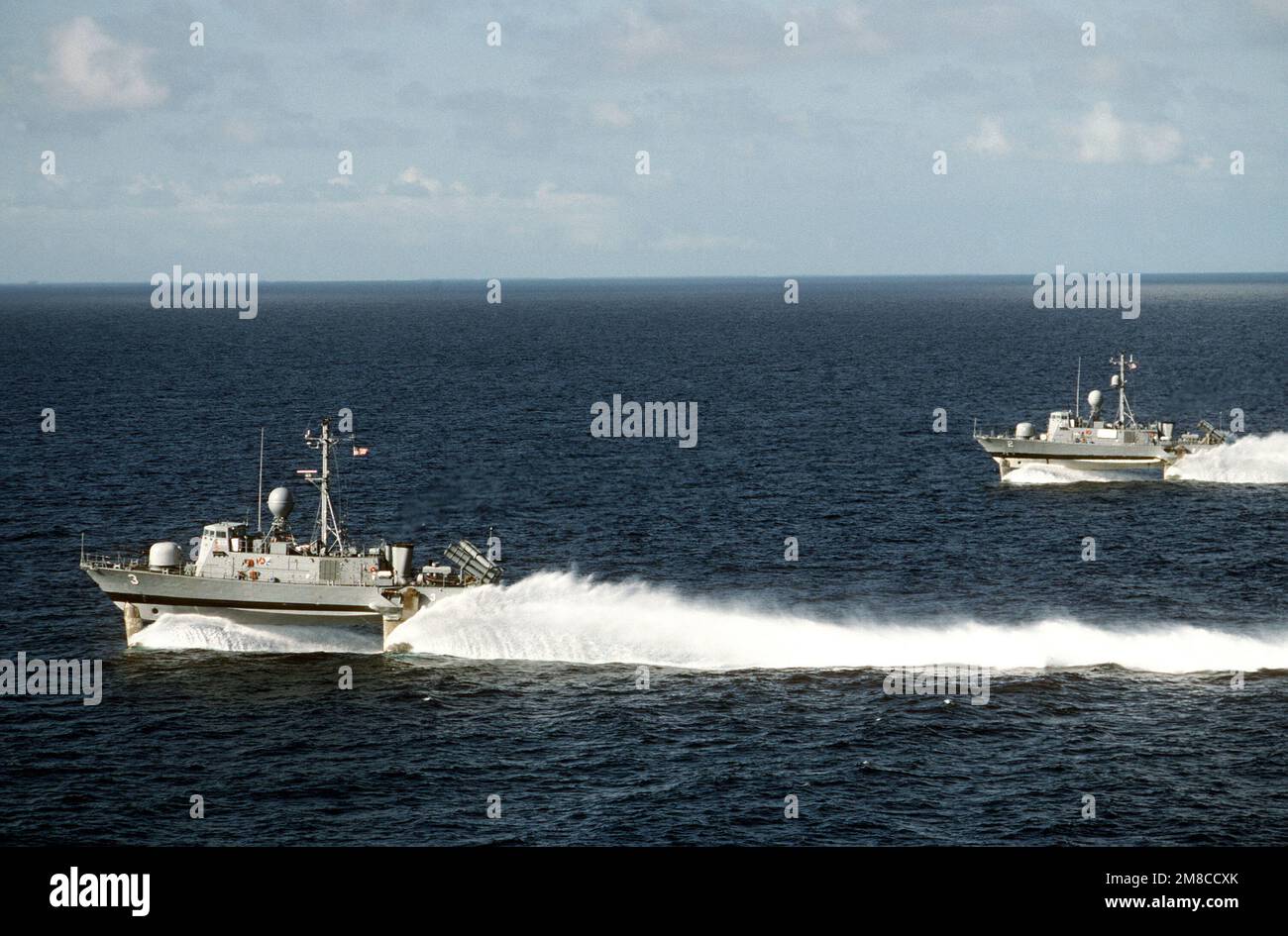 The patrol combatant missile hydrofoil USS TAURUS (PHM 3), left, and ...