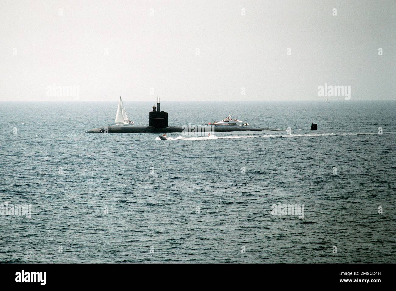 Civilian pleasure boats pass near a surfaced Los Angeles-class nuclear ...