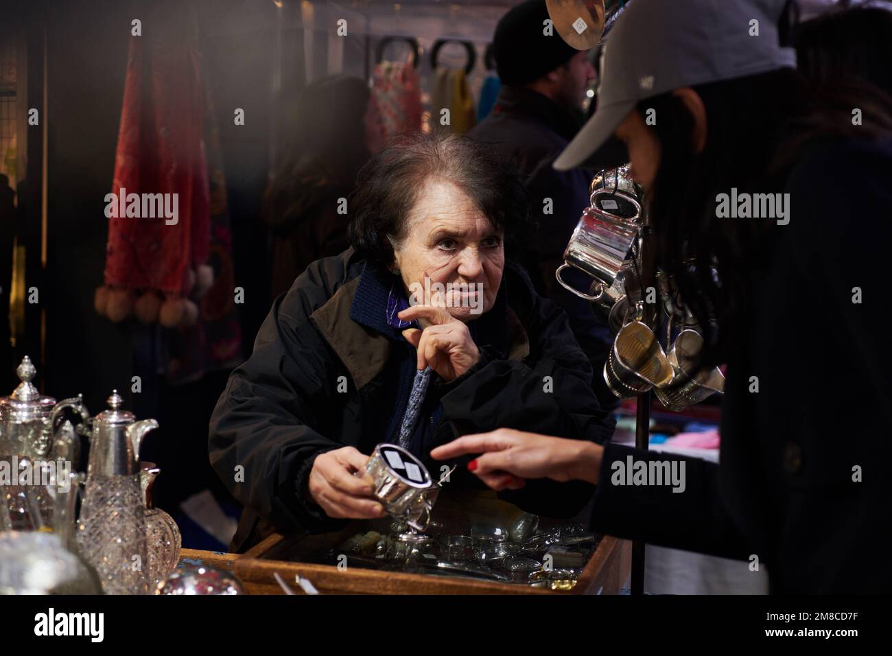 Elderly sales lady selling silver at Portobello Market in Notting Hill ...
