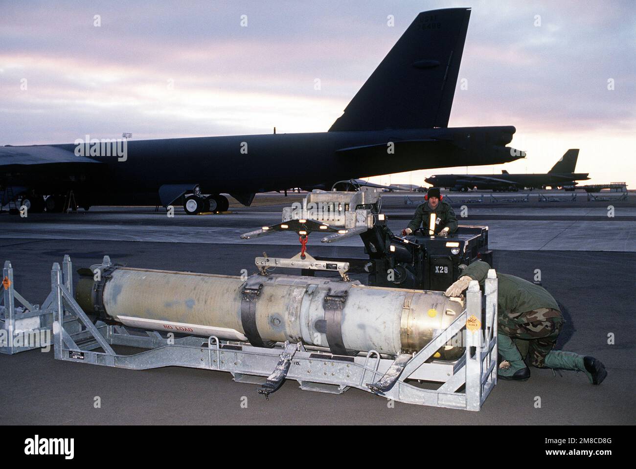 Airmen from the 42nd Munitions Maintenance Squadron prepare to load a ...
