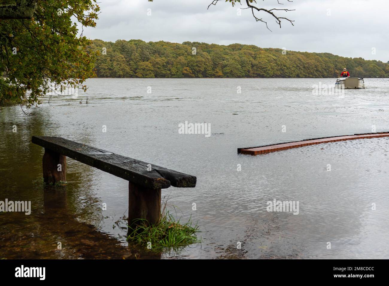bench surrounded by water at high tide in the River Hamble Hampshire ...