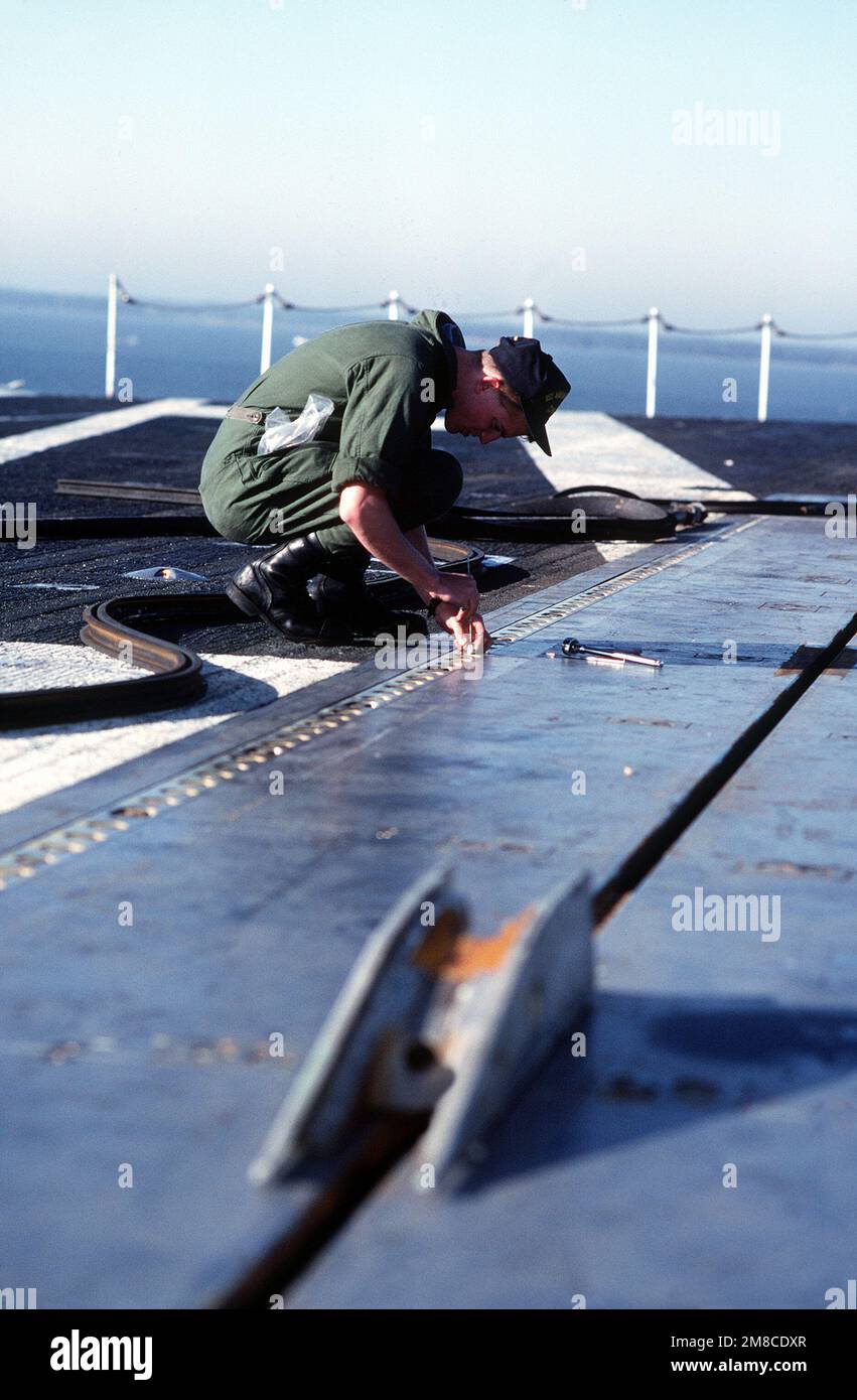 A sailor adjusts a catapult on the nuclear-powered aircraft carrier USS ...