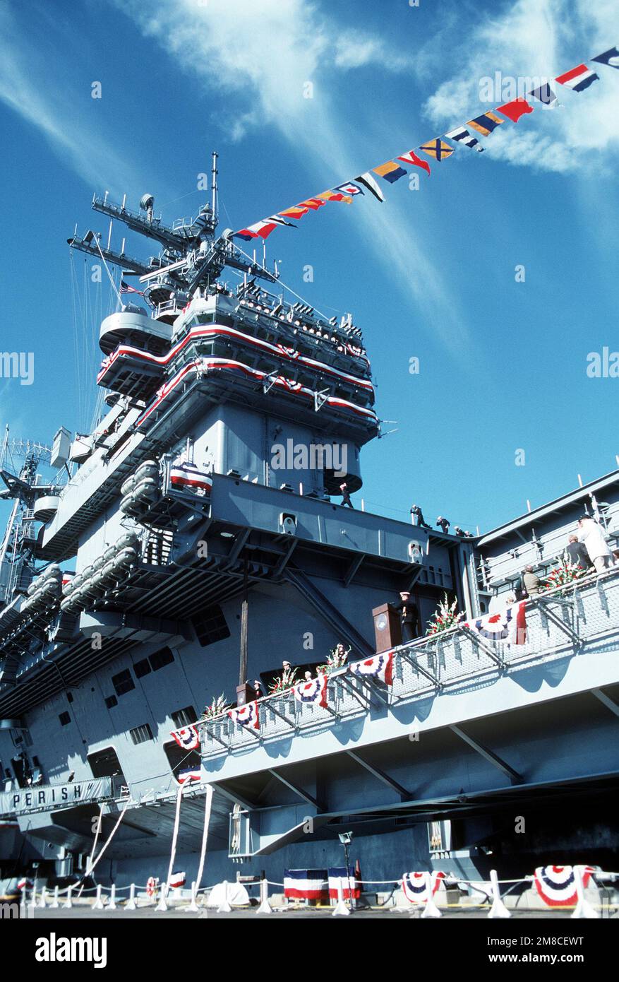 Bunting, flowers, and pennants decorate the nuclear-powered aircraft ...