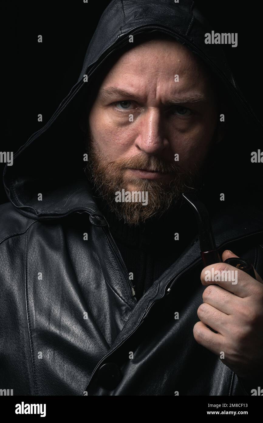 Portrait of a Bearded man in Black Rain Jacket Smoking a Pipe Stock ...