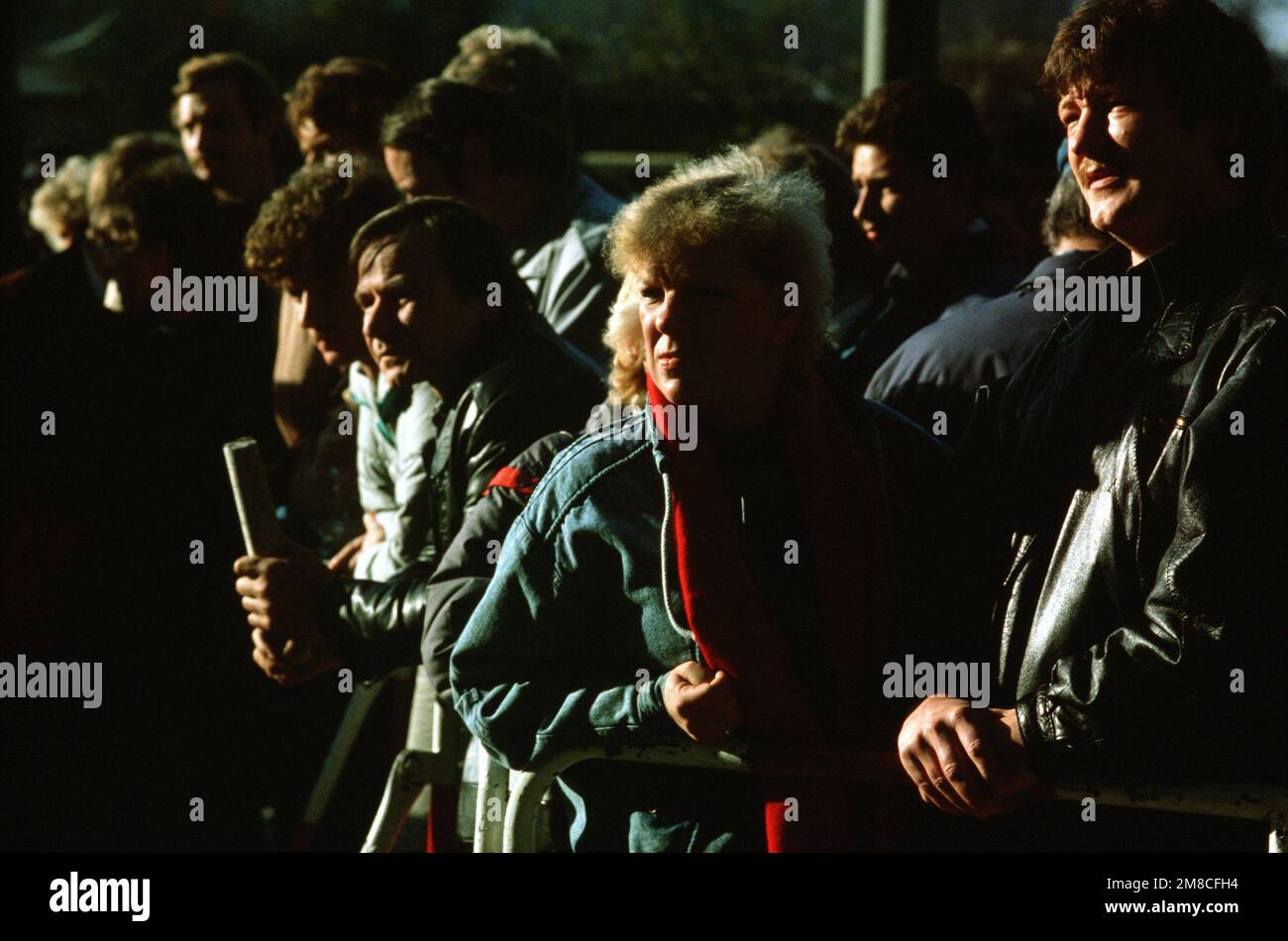 A crowd of East German refugees gathers outside the refugee center in ...
