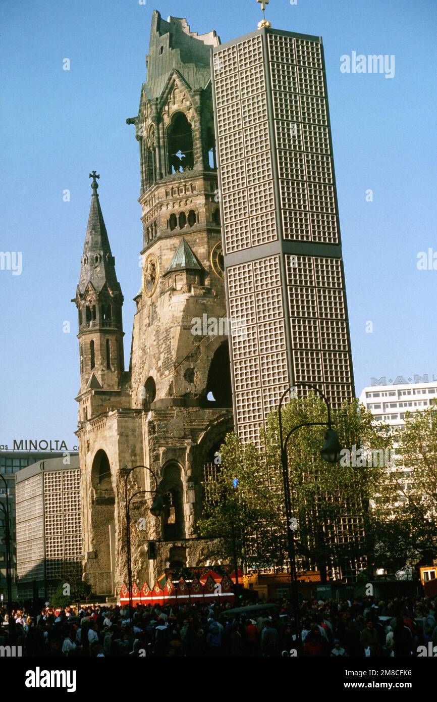 A modern church tower stands beside an ancient one on the Ku'damm in ...