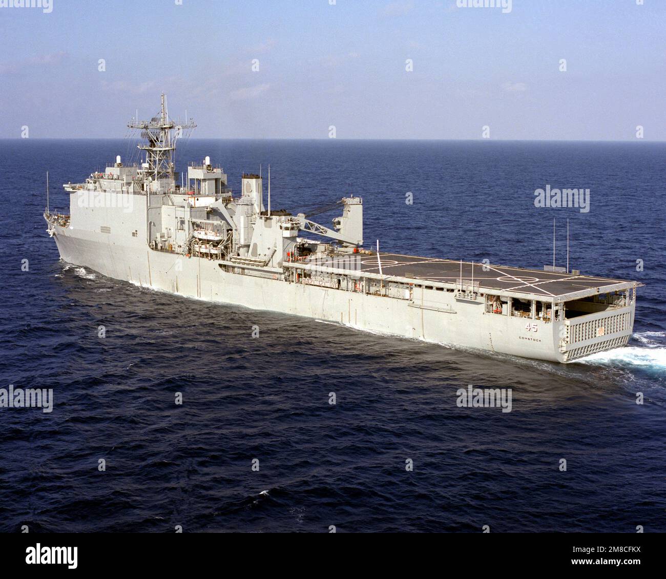 A port quarter view of the dock landing ship COMSTOCK (LSD-45) underway ...