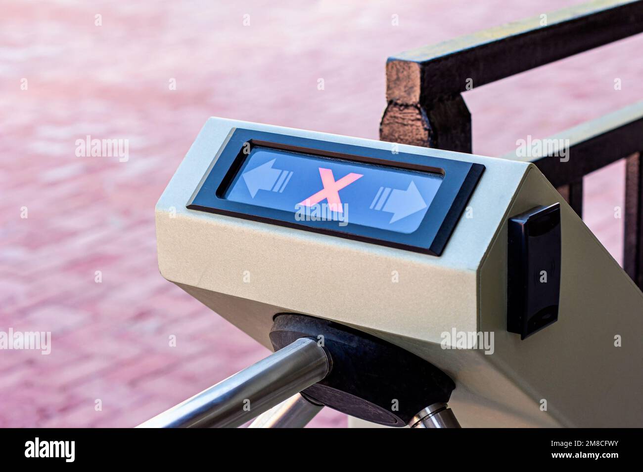 Modern automated metallic turnstile entrance system with stop sign on ...