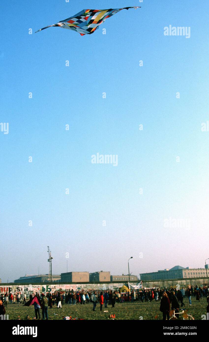 East Germans fly a large kite on the west side of the Berlin Wall at ...