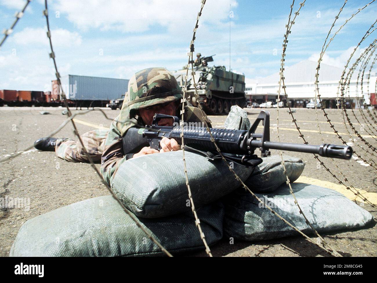 A member of the 4th Bn., 6th Inf., 5th Inf. Div., aims his M-16A2 rifle ...