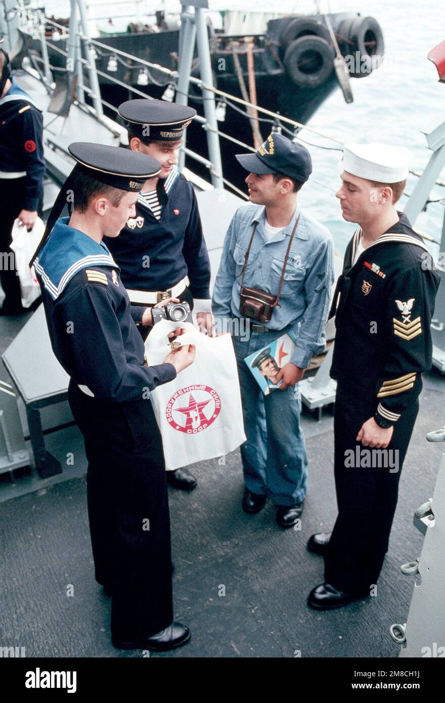 Soviet sailors and United States (US) sailors converse aboard the ...