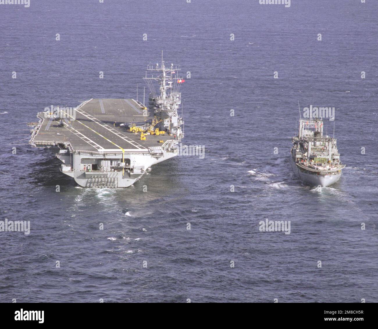 A stern view of the ammunition ship USS SURIBACHI (AE-21) and the ...