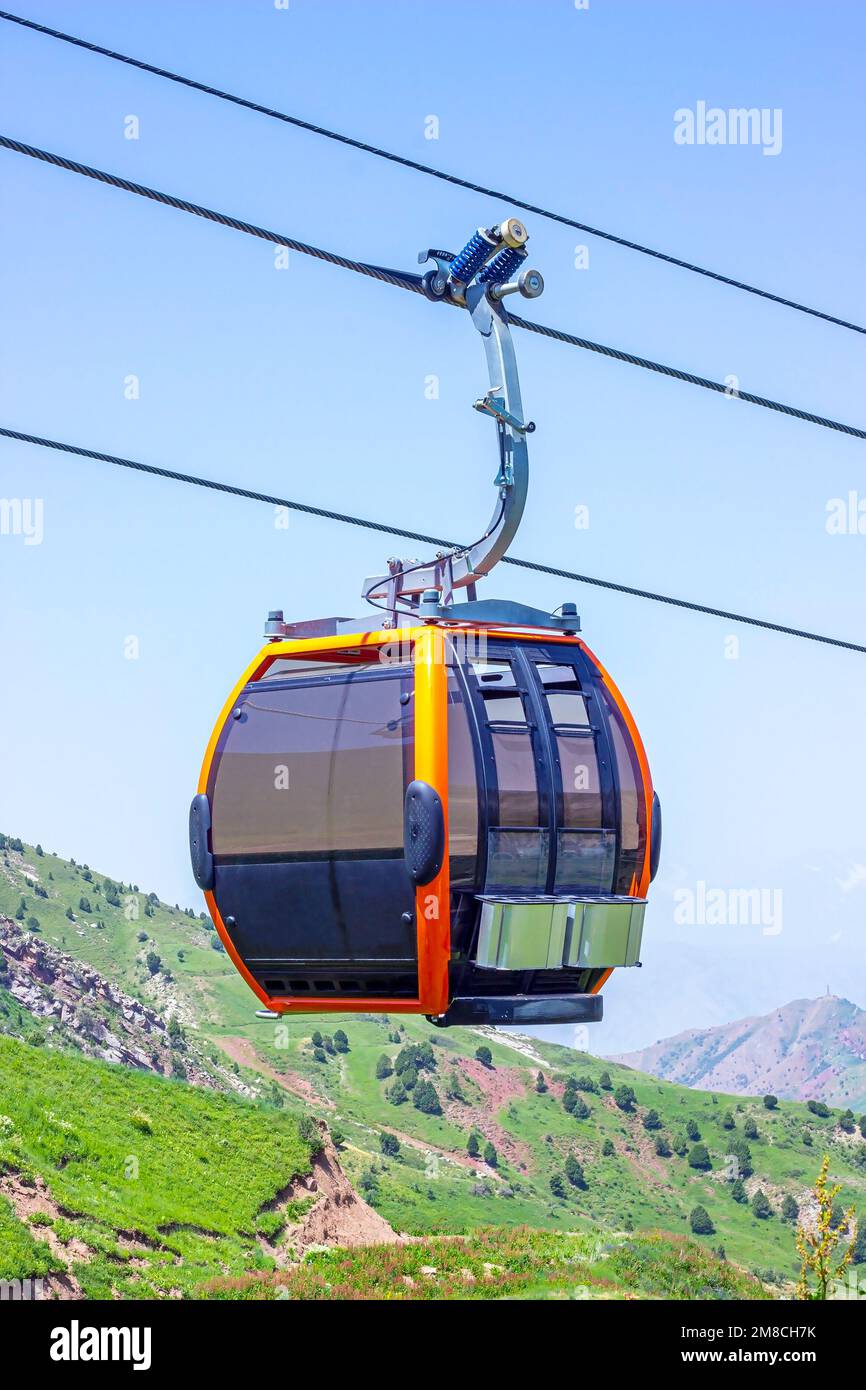 Funicular or cable car for tourists on green mountains and blue sky ...