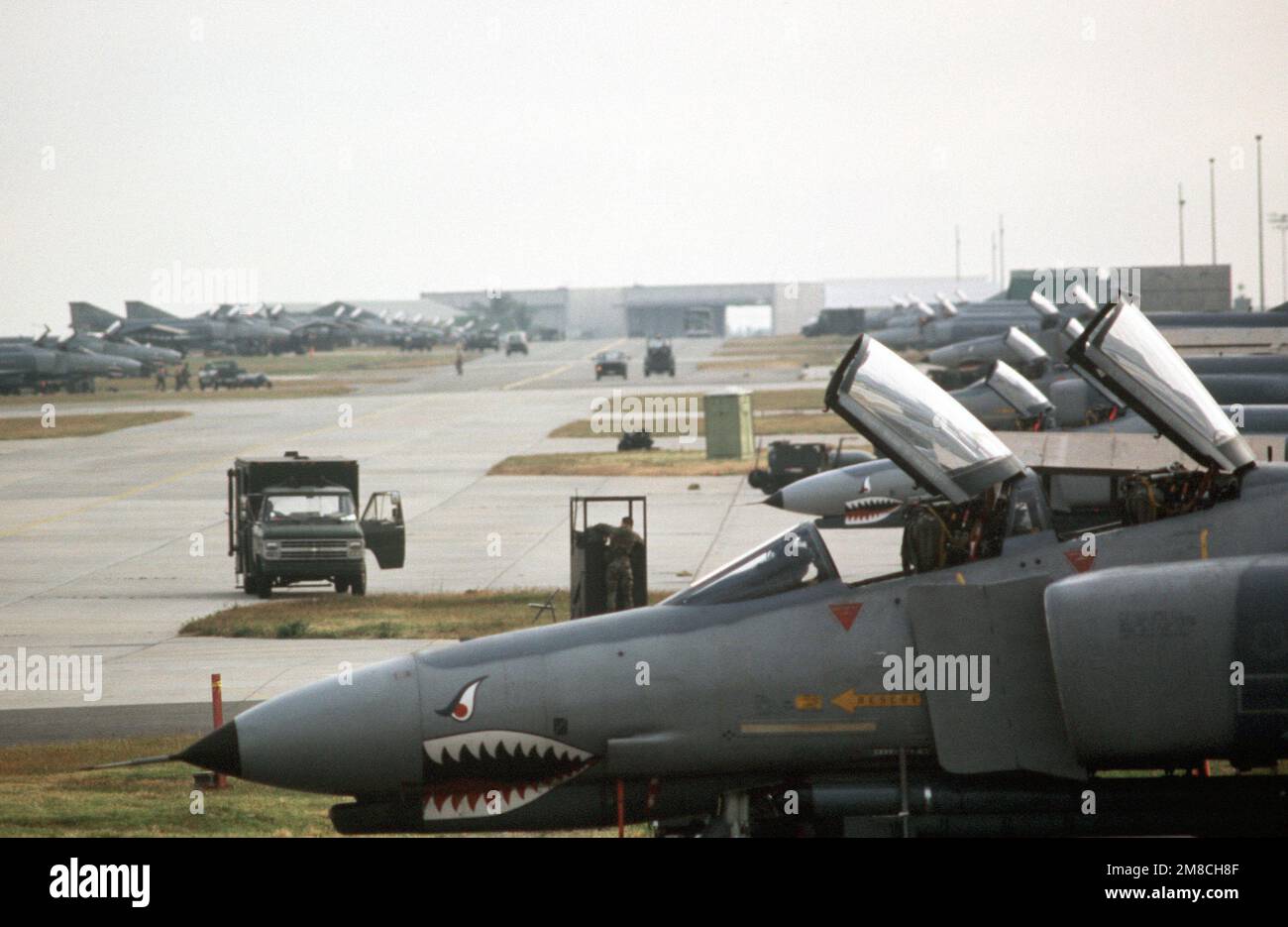 An F-4E Phantom II aircraft, foreground, and other Phantom aircraft of ...